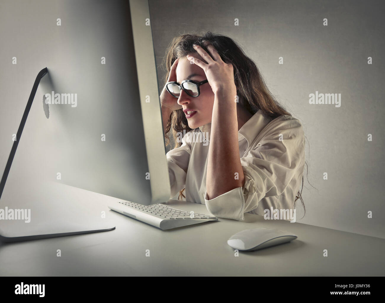 Blond woman working on computer Stock Photo - Alamy