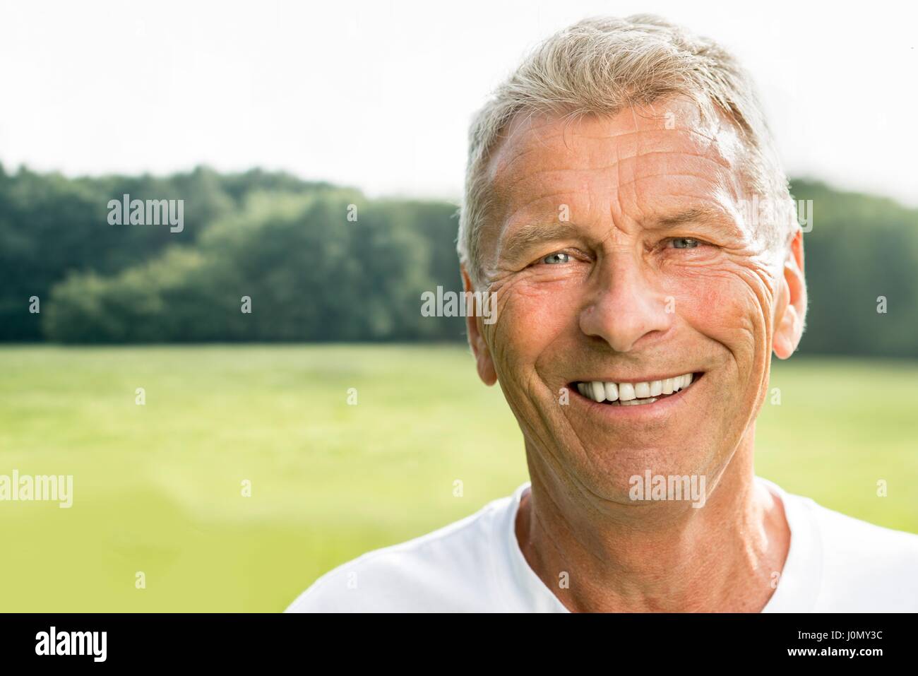 Senior man smiling towards camera, portrait Stock Photo - Alamy
