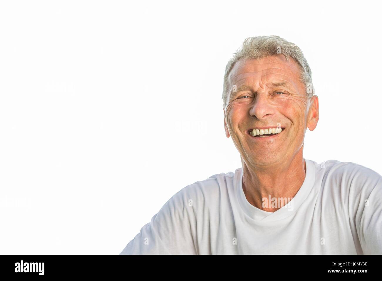Senior man smiling against white background, portrait Stock Photo - Alamy