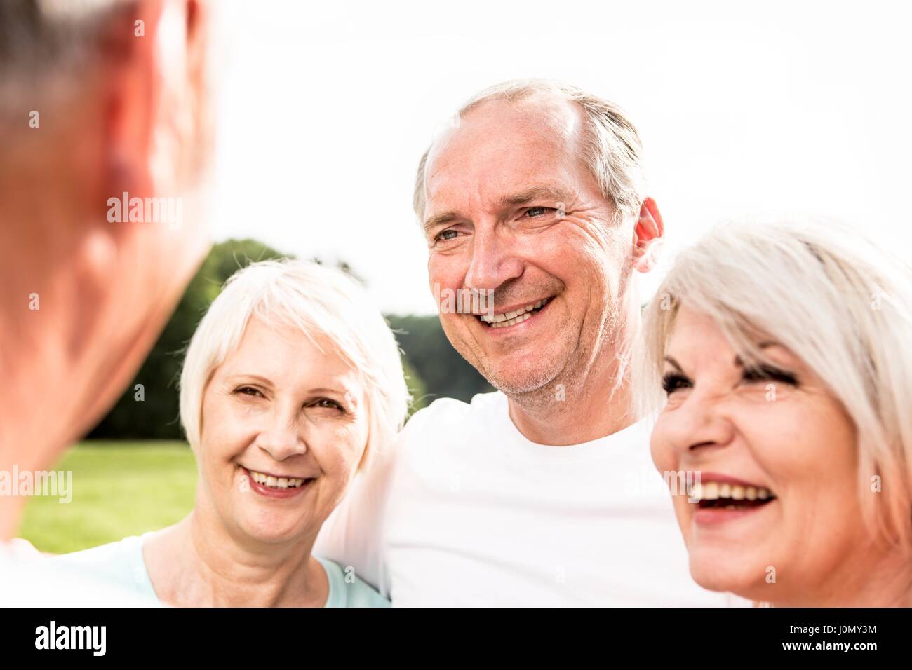 Four people smiling, portrait Stock Photo - Alamy