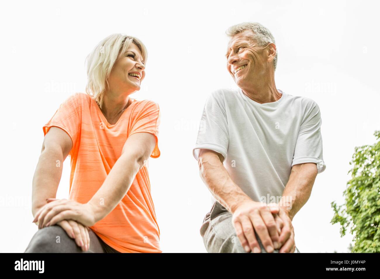 Couple smiling, low angle view Stock Photo - Alamy
