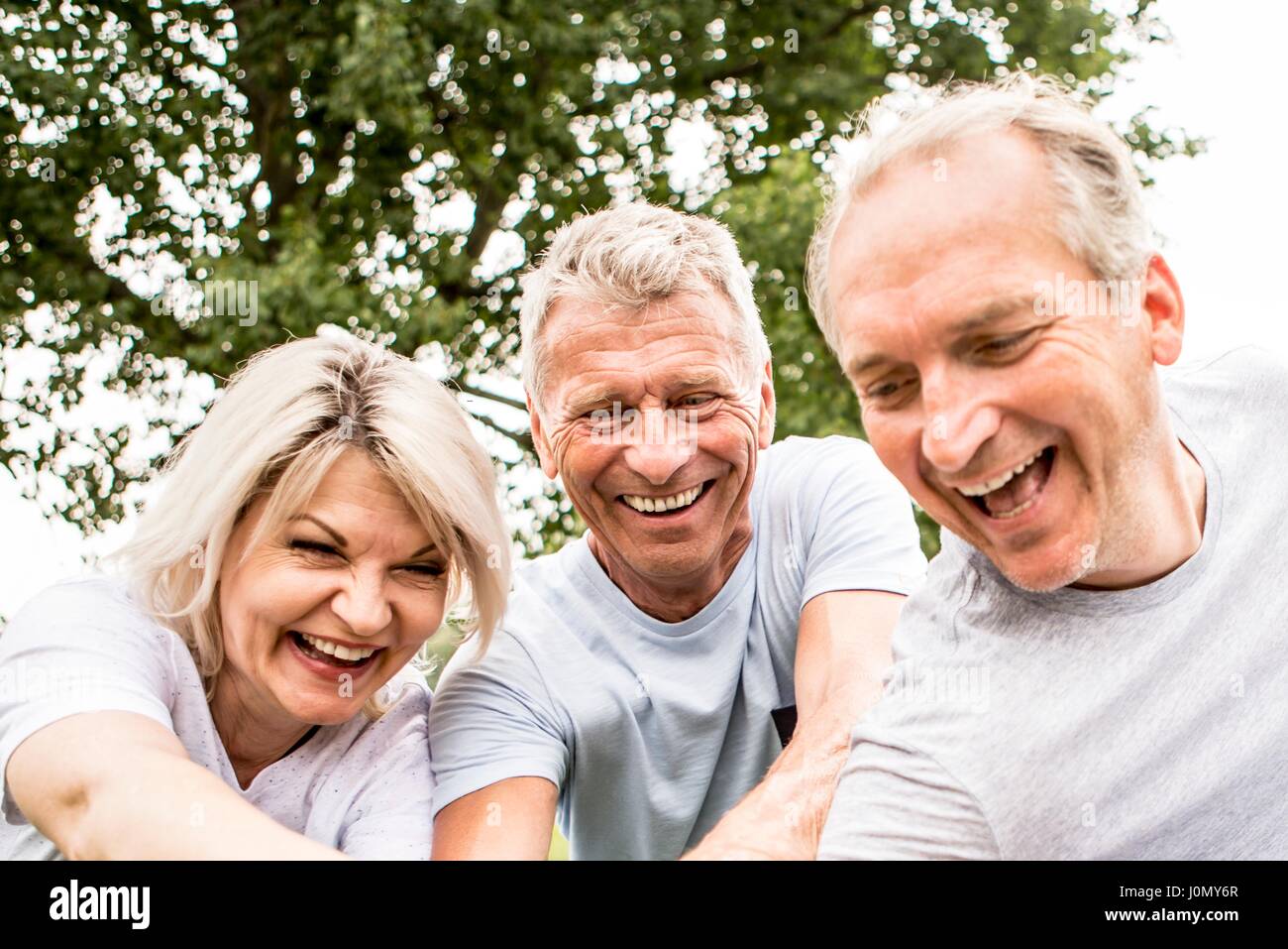 Three people smiling, candid portrait Stock Photo - Alamy