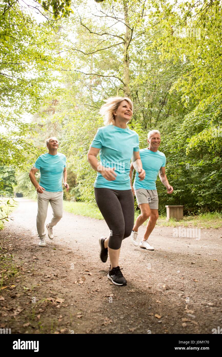 Three senior people running in race, smiling Stock Photo - Alamy
