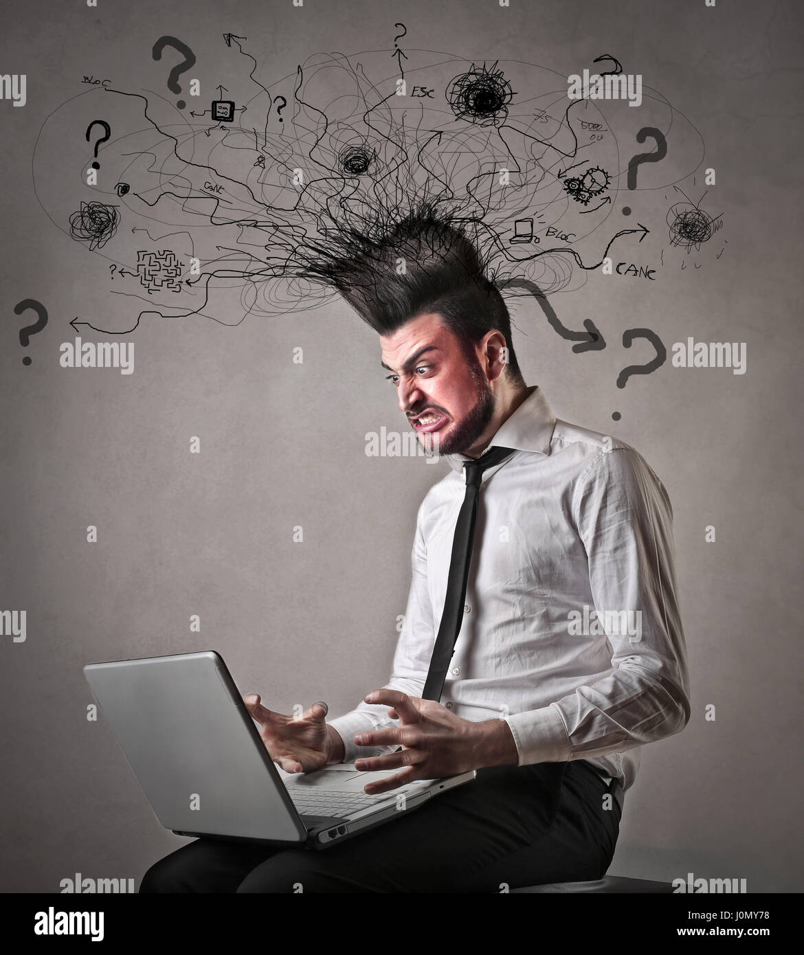 Man being mad in front of laptop Stock Photo - Alamy