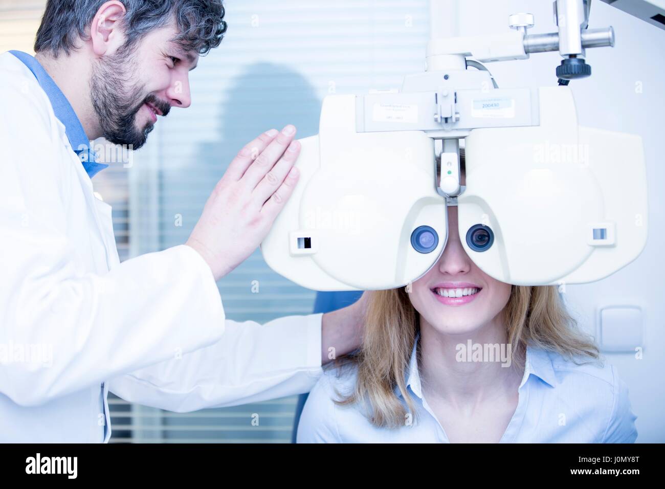 Young woman having eye exam performed by Optometrist Stock Photo - Alamy