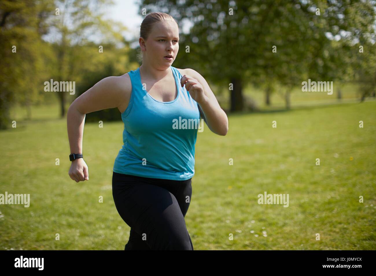 Young woman running on path Stock Photo - Alamy