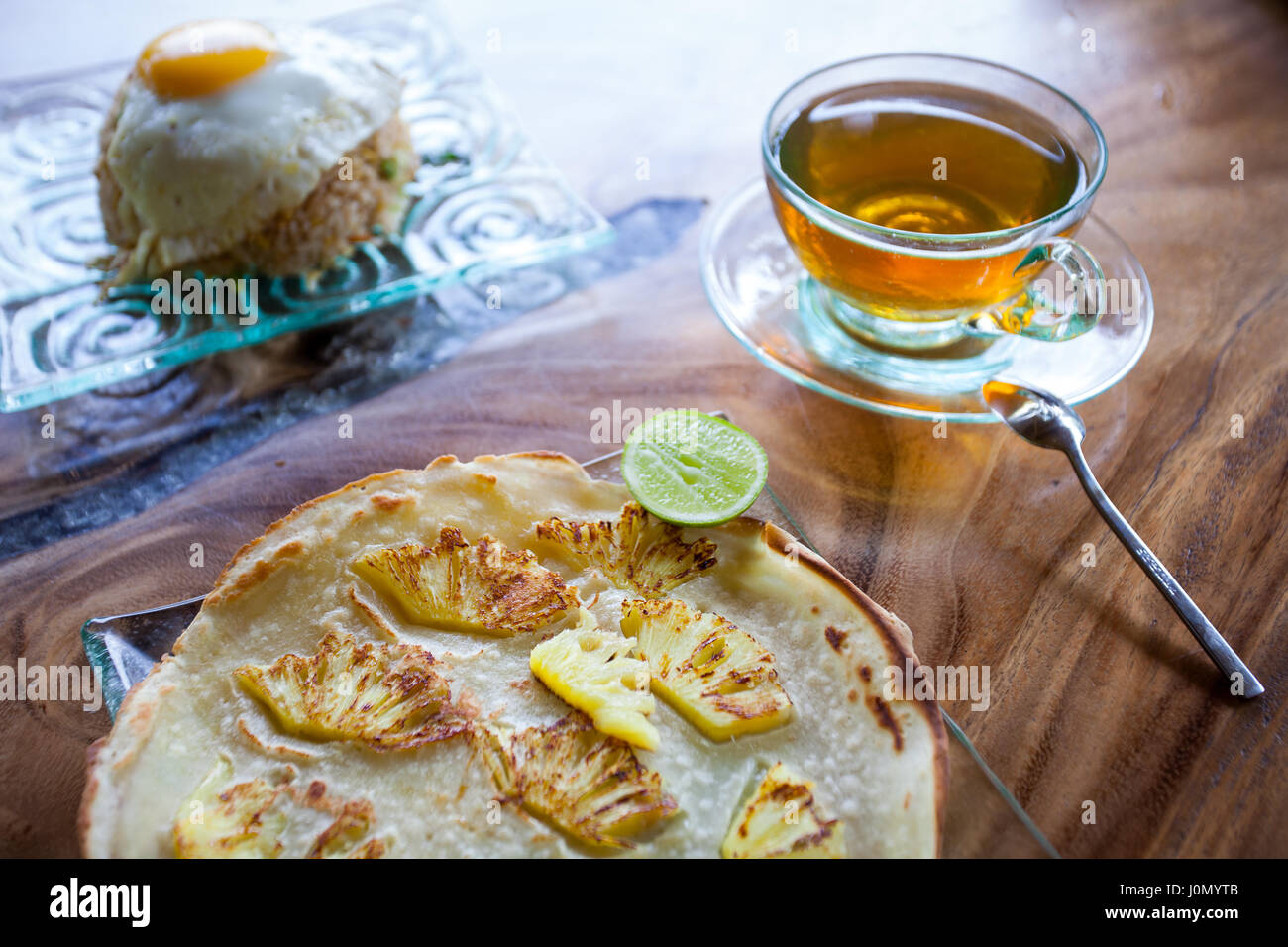 Traditional Asian Breakfast, rice with egg, pancake with pineapple and ...