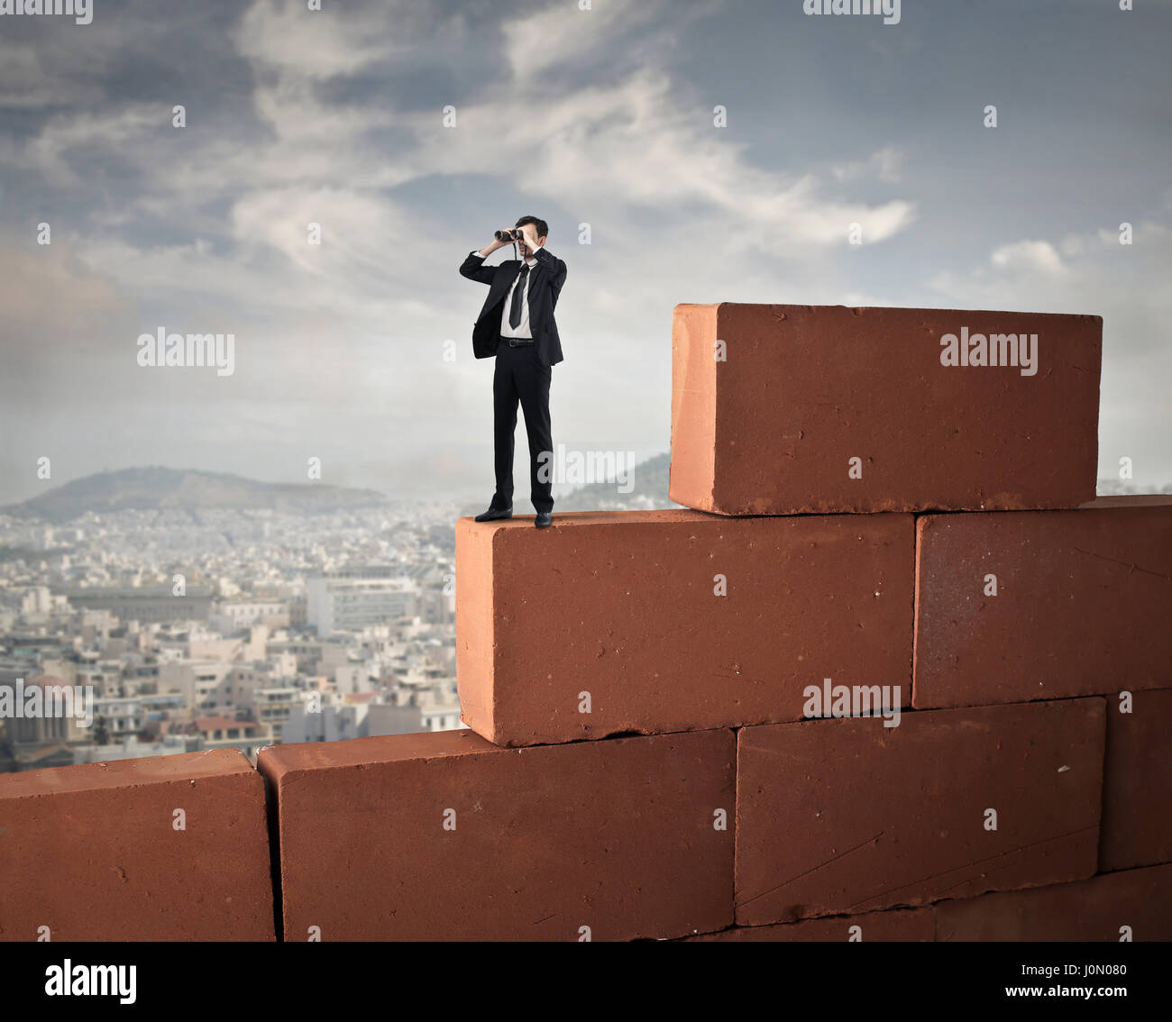 Man on huge bricks Stock Photo - Alamy
