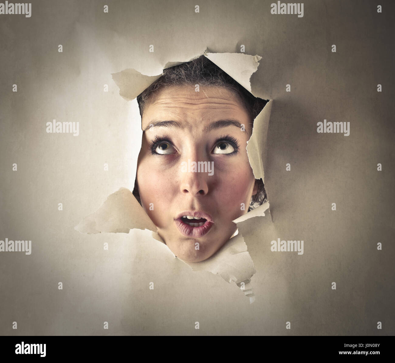 Woman breaking through paper Stock Photo - Alamy