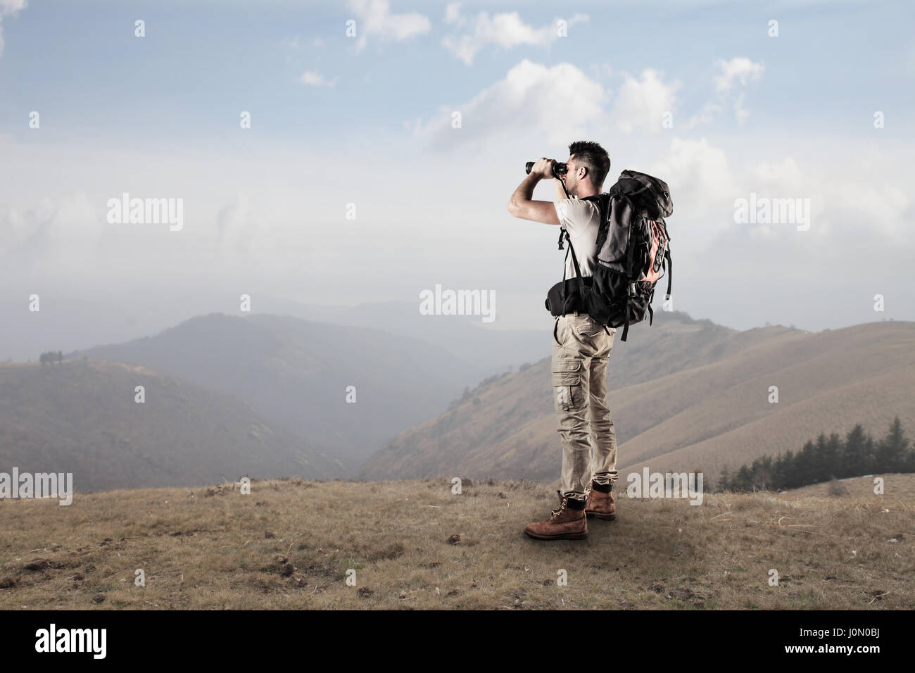 Adventurous man hiking Stock Photo - Alamy