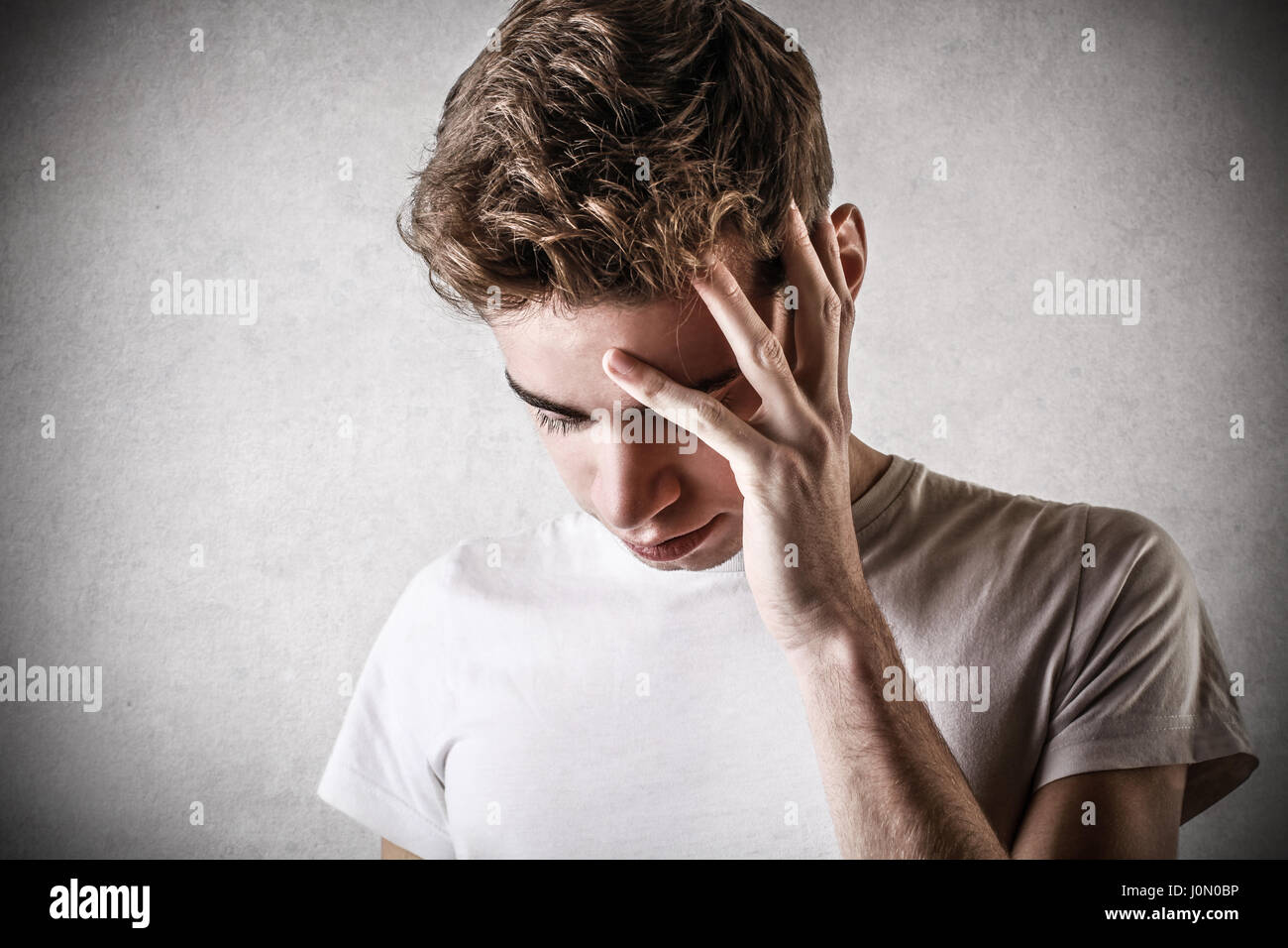 Young man being worried Stock Photo - Alamy
