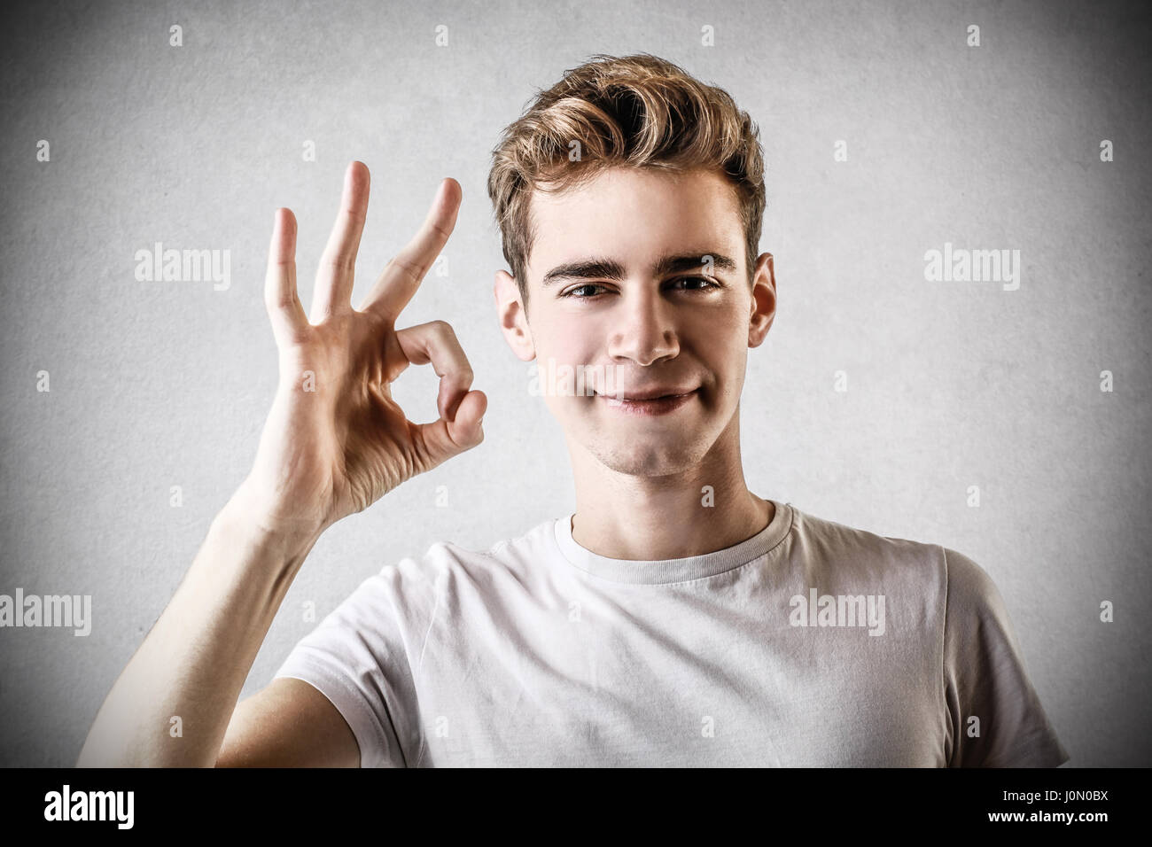 Young man showing perfect sign Stock Photo - Alamy