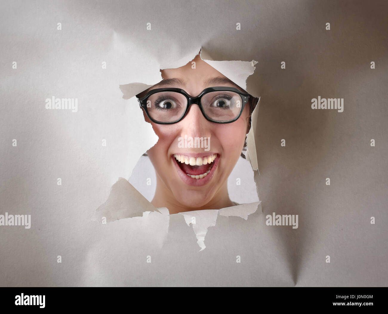 Businesswoman behind paper wall Stock Photo - Alamy