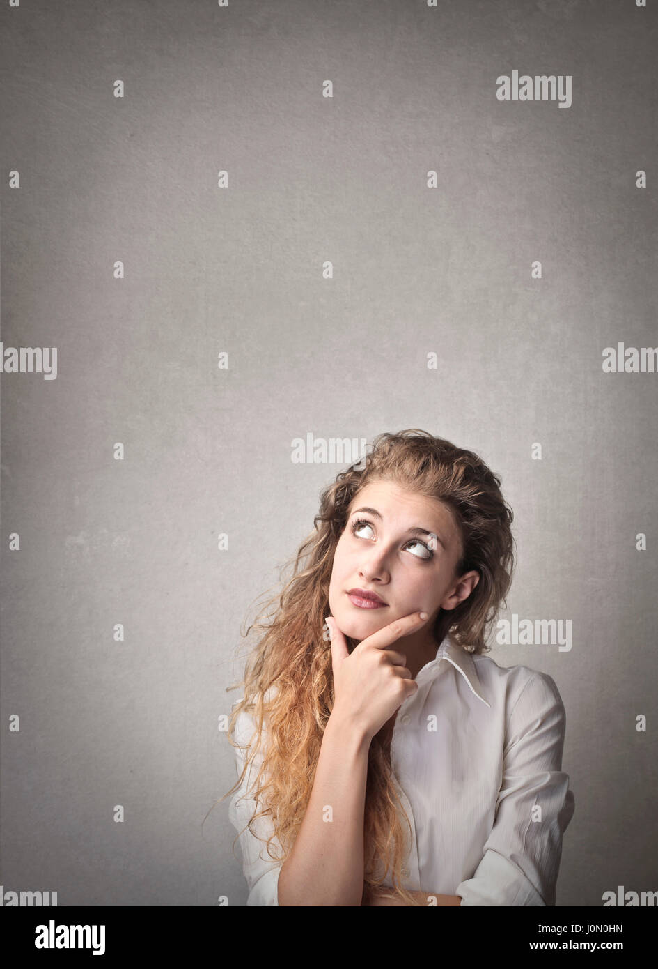 Blond woman thinking inside Stock Photo - Alamy