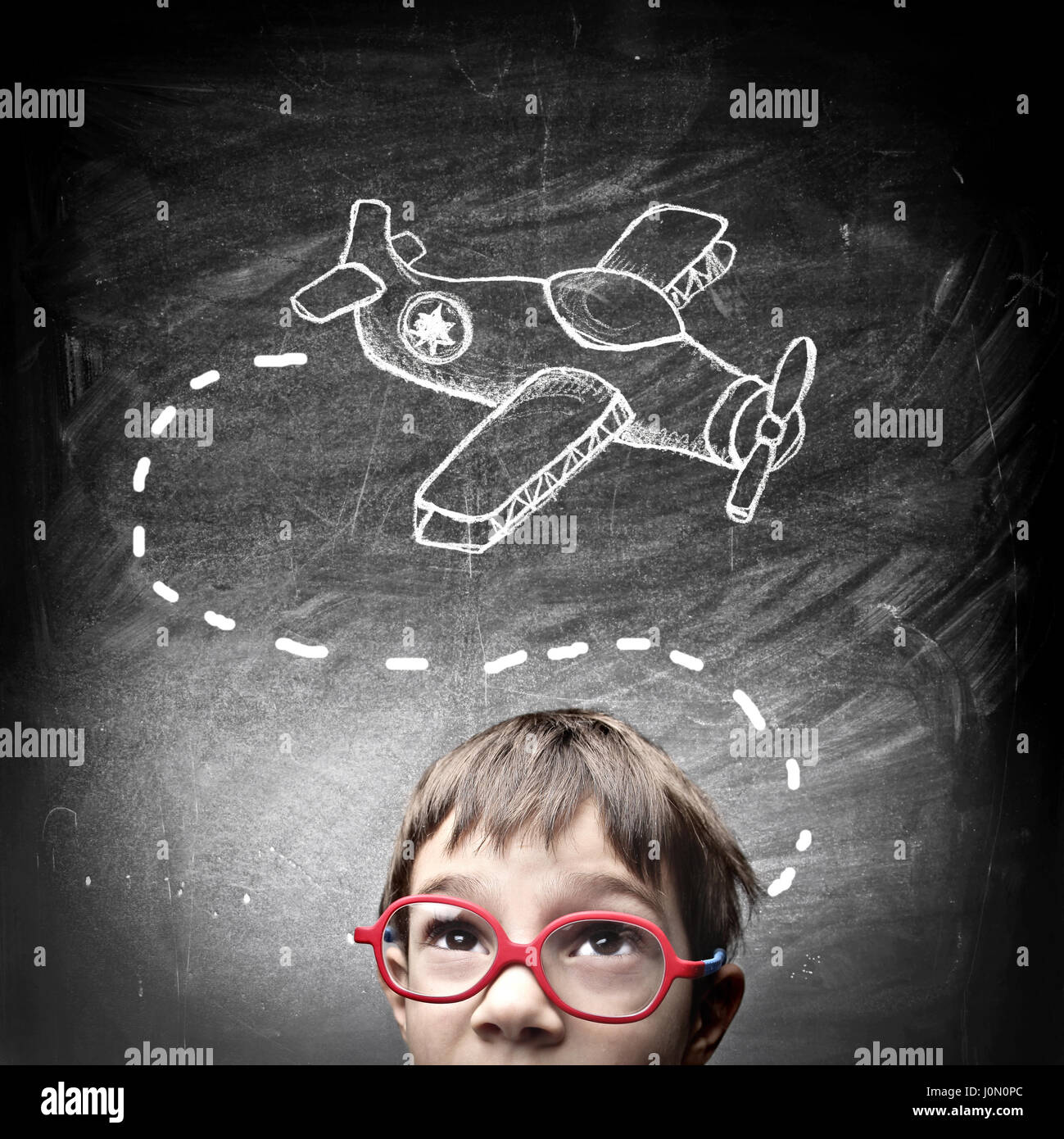 Young child thinking of airplane Stock Photo - Alamy