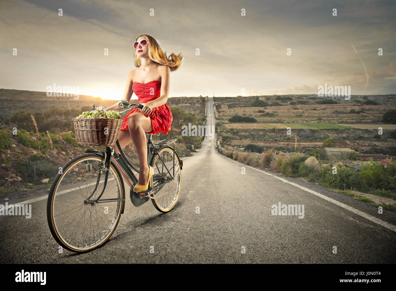 Woman riding bike on the road Stock Photo - Alamy