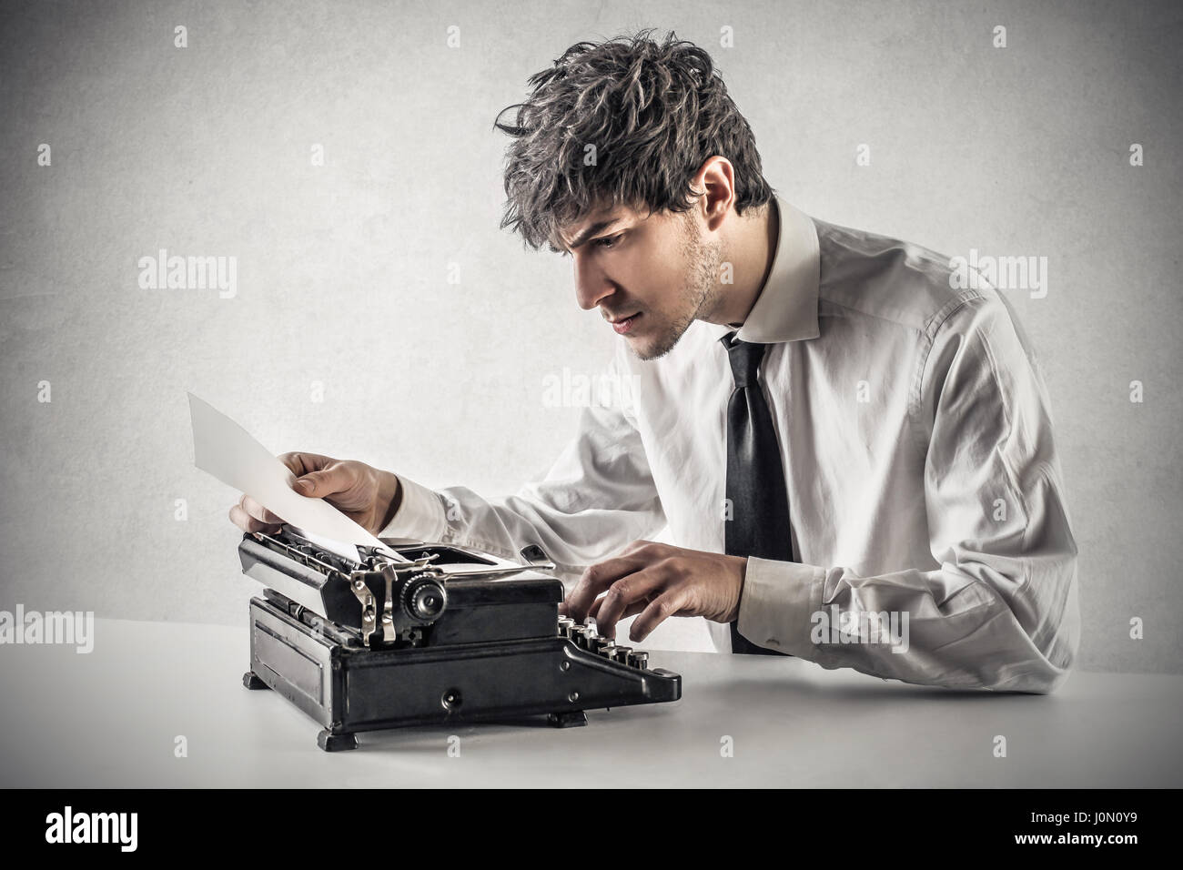 Man using typewriter Stock Photo - Alamy