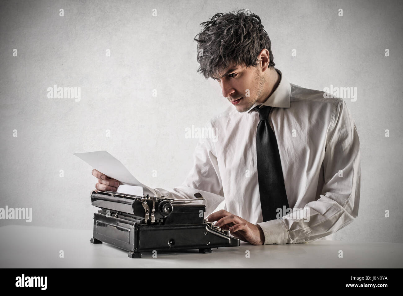 Man working with typewriter Stock Photo - Alamy