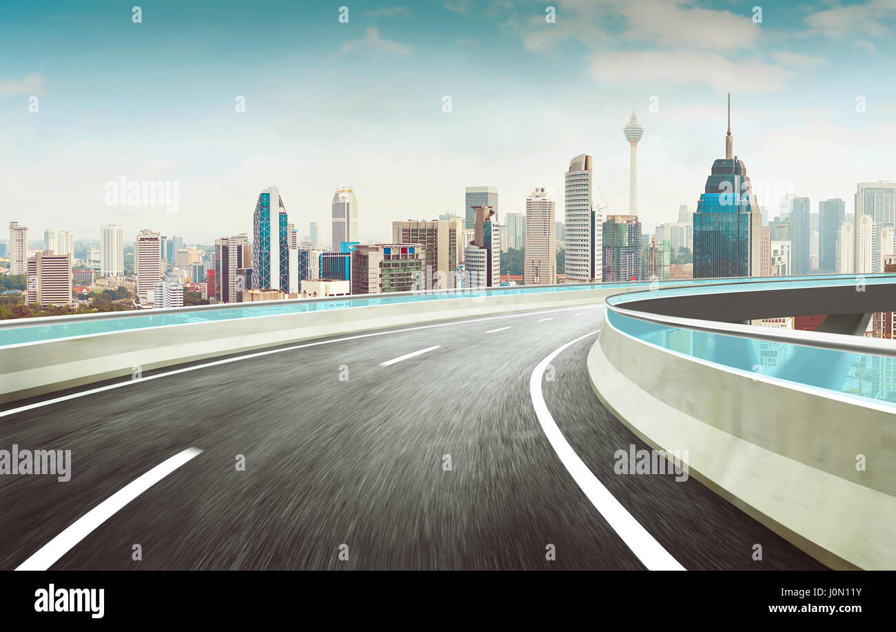 Highway overpass motion blur effect with modern city skyline background ...