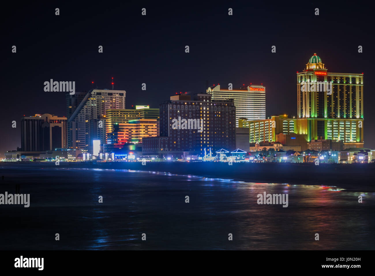 The skyline and Atlantic Ocean at night, in Atlantic City, New Jersey ...