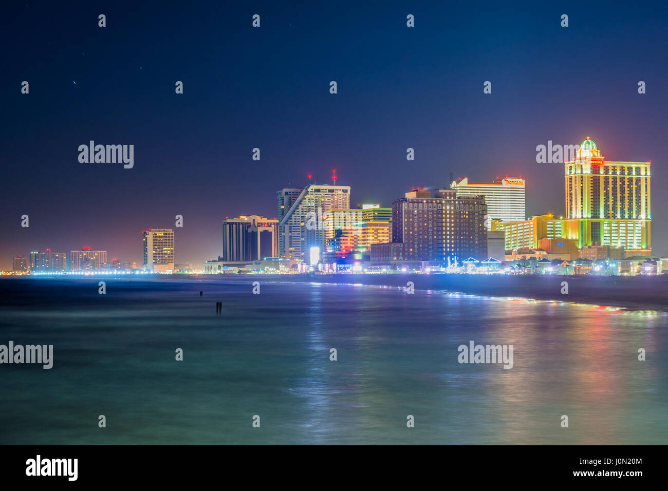 The skyline and Atlantic Ocean at night, in Atlantic City, New Jersey ...