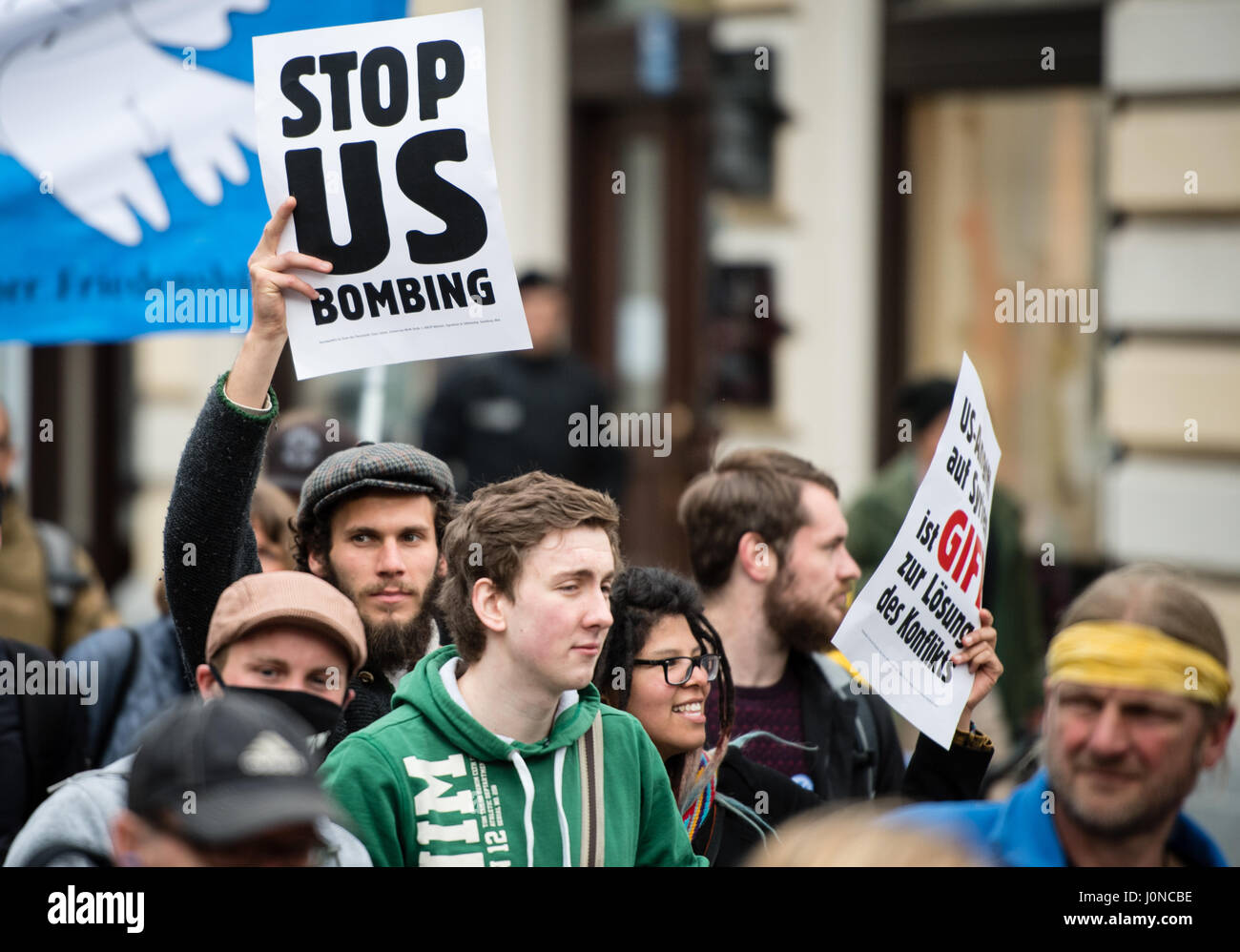 Munich, Germany. 15th Apr, 2017. A member of the peace movement carries ...