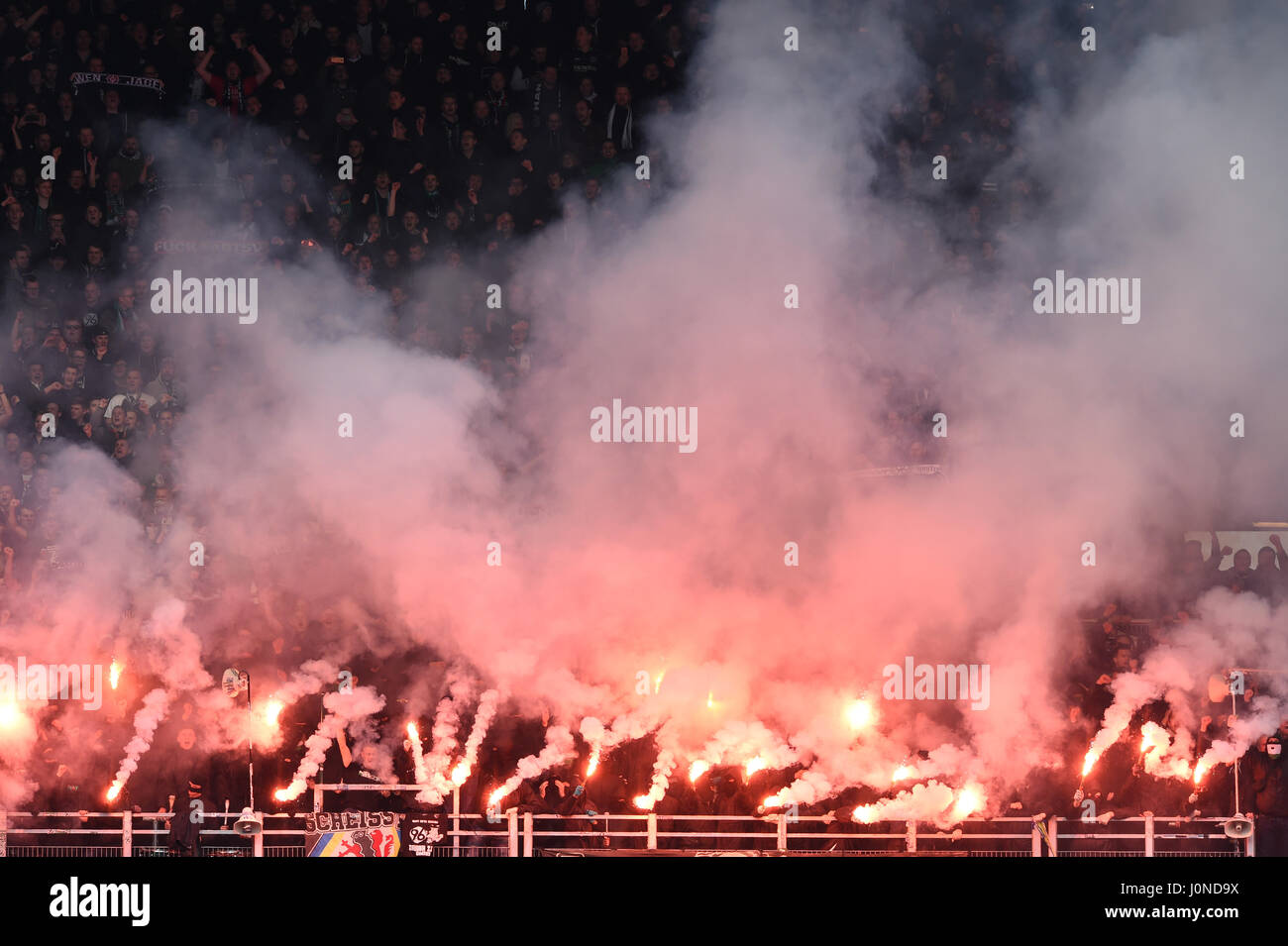 Hanover, Germany. 15th Apr, 2017. Hanover's fans light up pyro technics ...