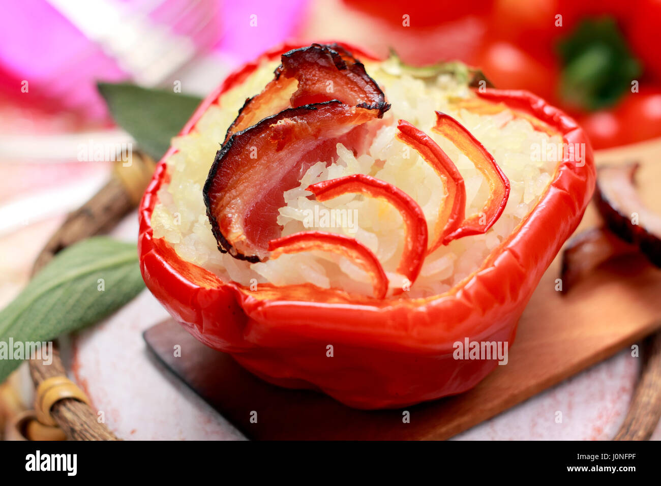 Roasted red pepper stuffed with rice and bacon. Very low depth of field ...
