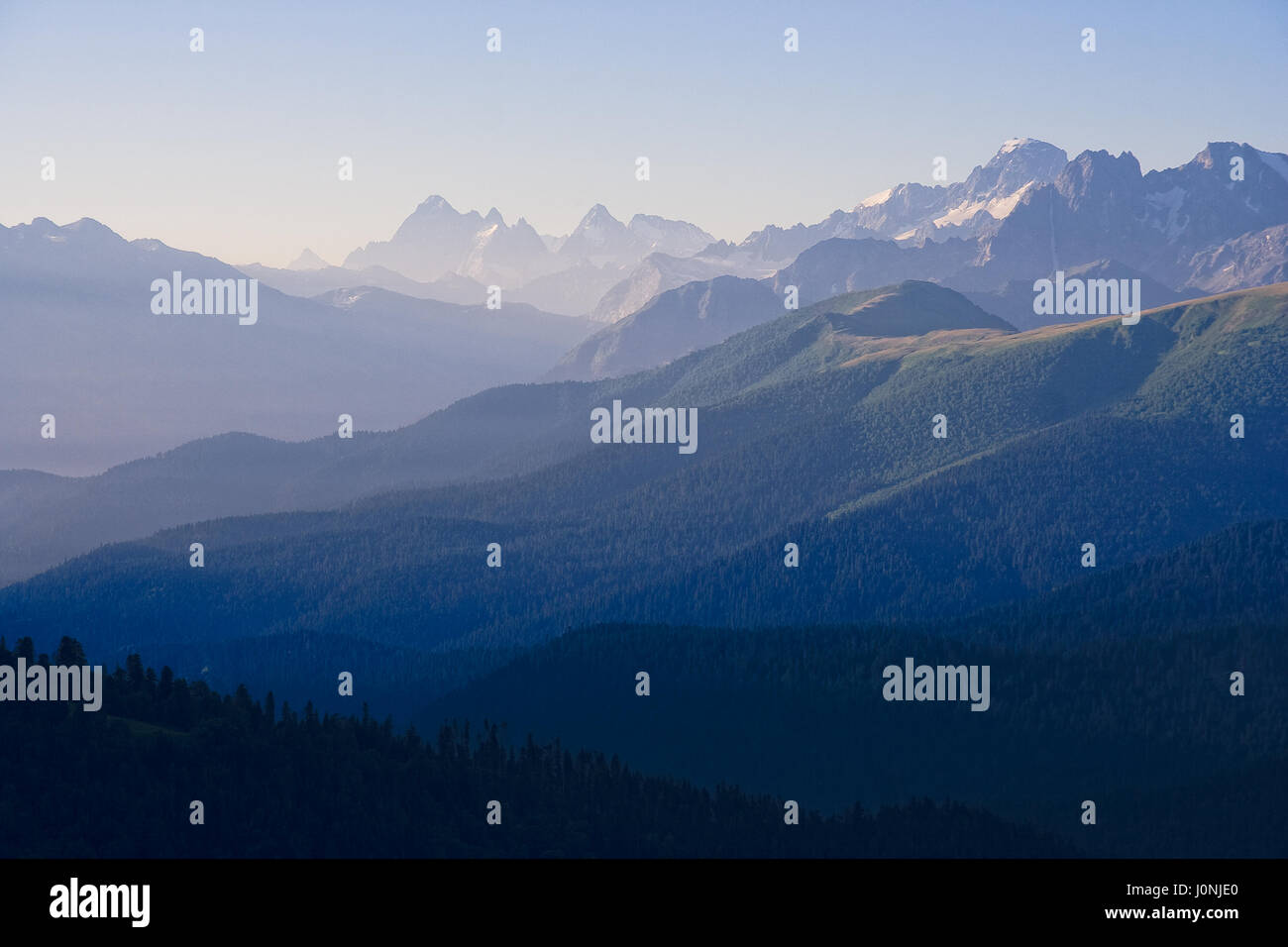The first rays of the sun illuminate the mountain in the Western ...