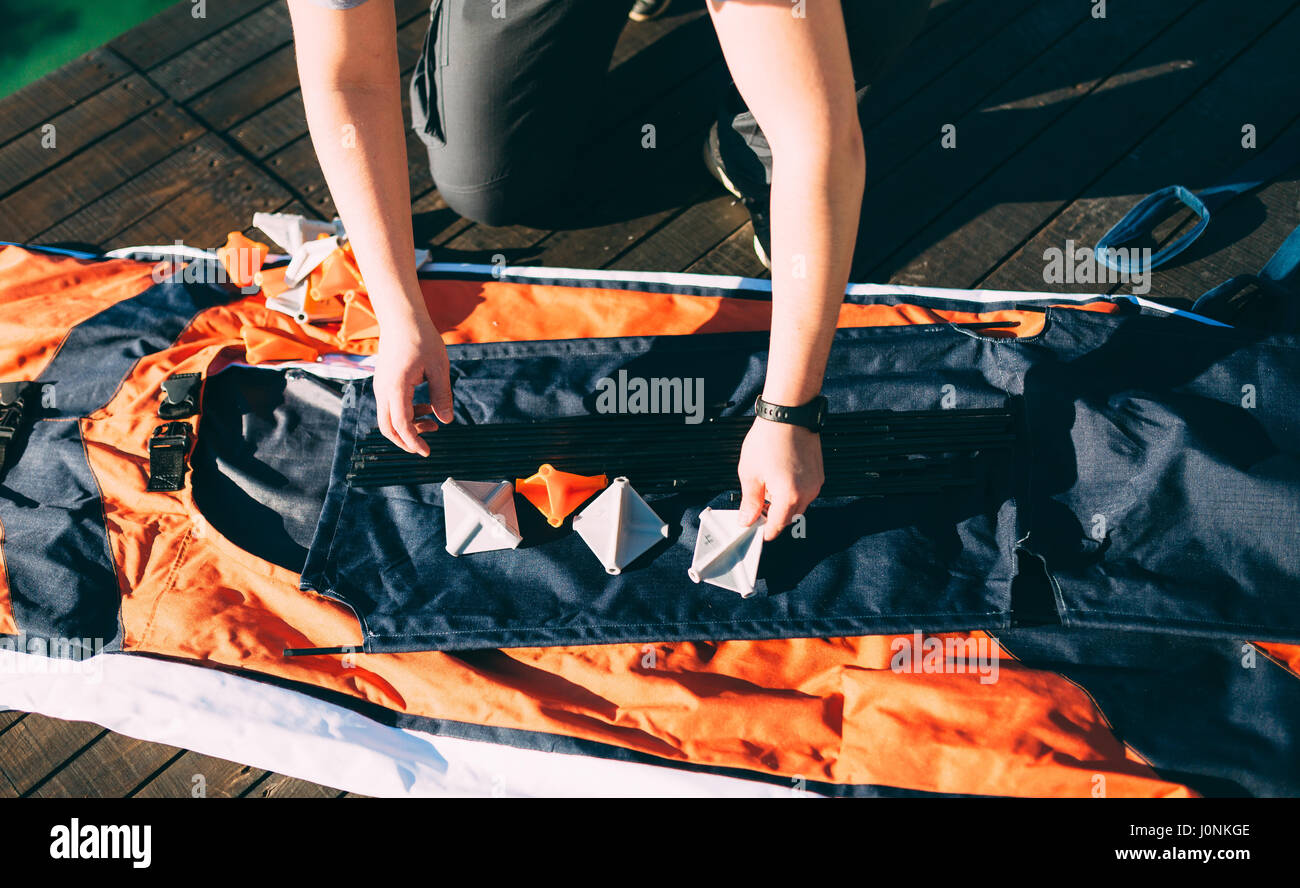 Folding kayak. Assembling the kayak on the shore of the Bay of Kotor ...