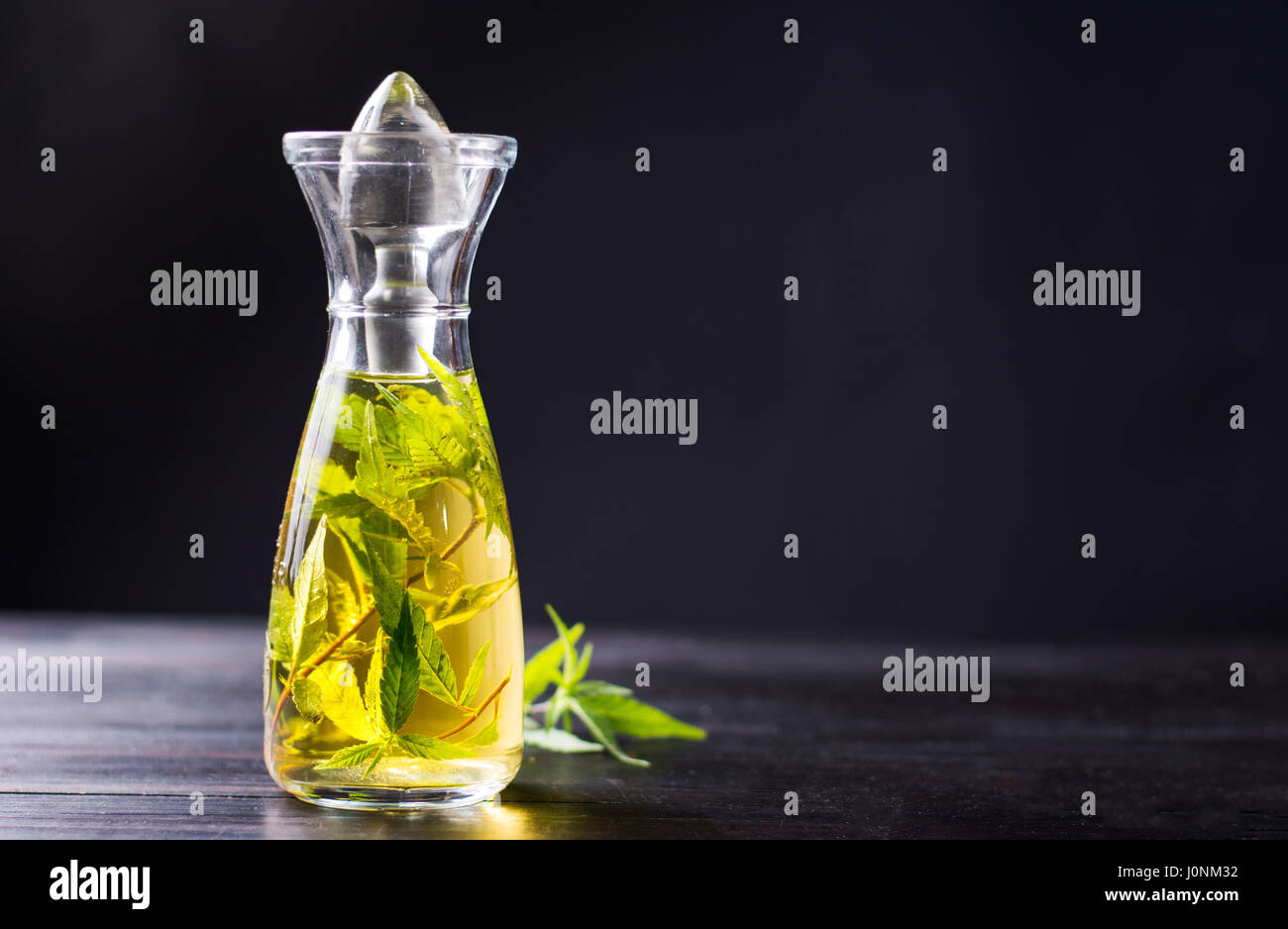 Marijuana alcohol drink in a bottle with leaves Stock Photo - Alamy