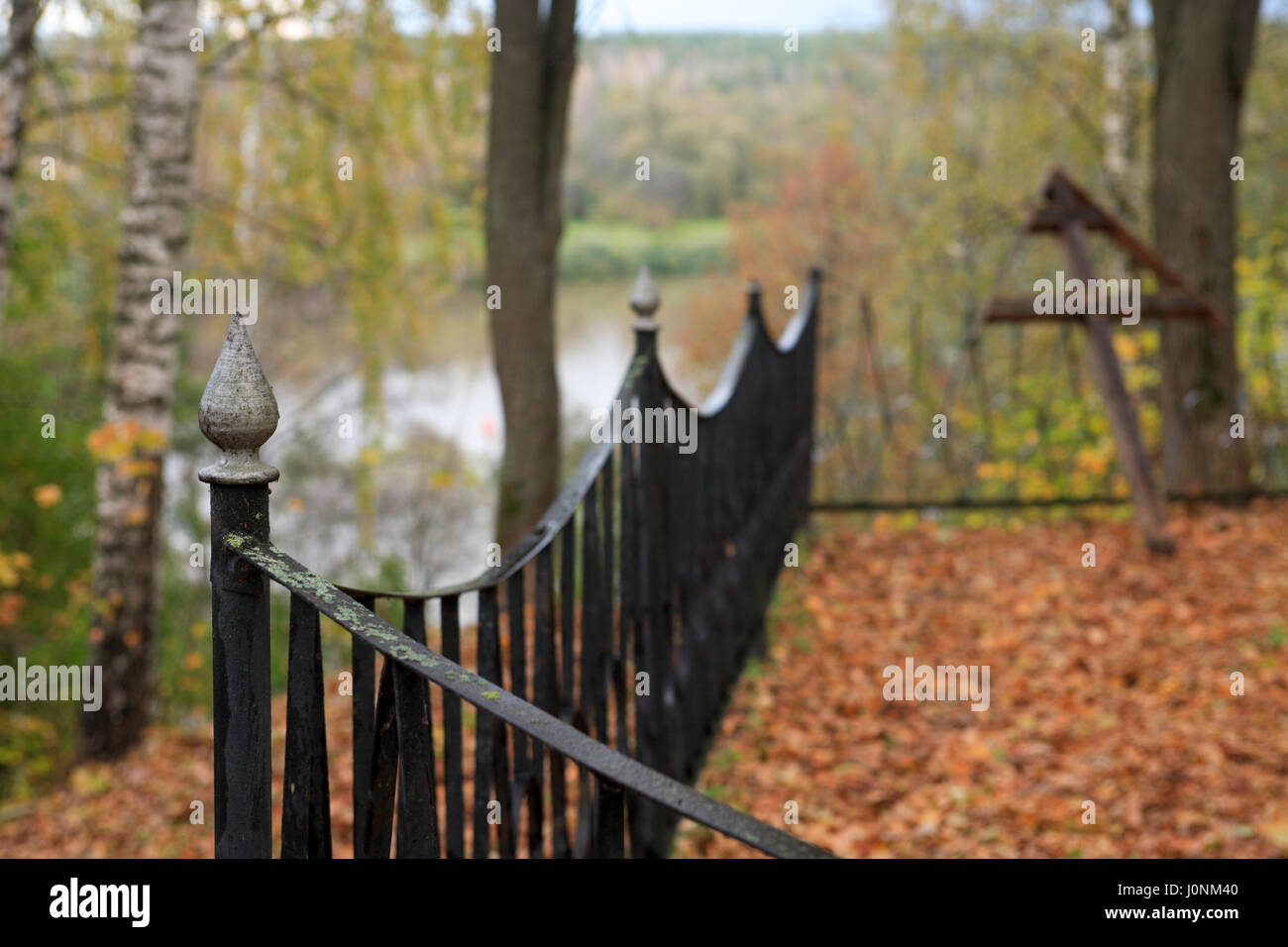 Fence of country graveyard in forest near river Stock Photo - Alamy