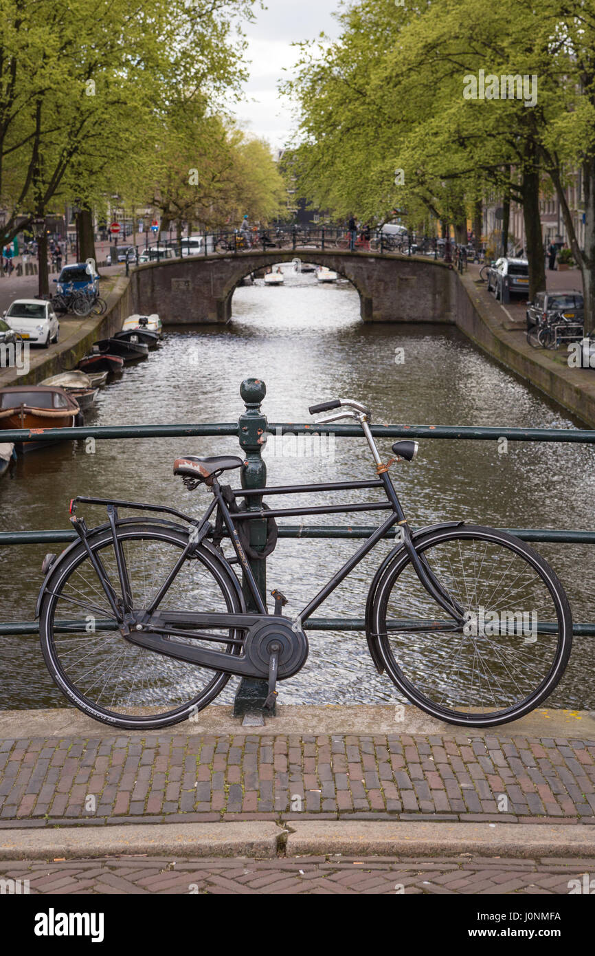 A dutch bike parked on a bridge with the Reguliersgracht in the ...