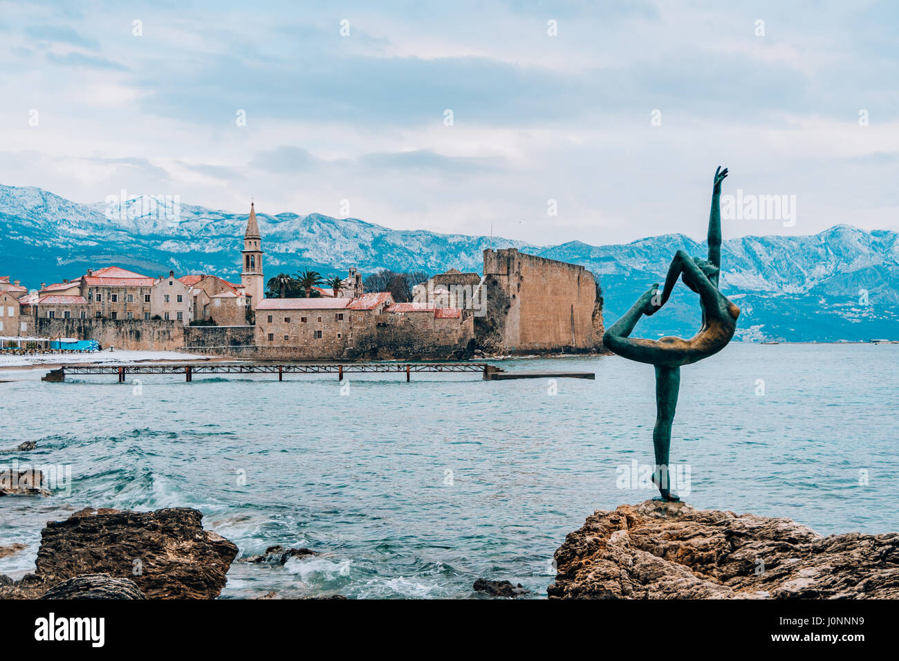 The statue Dancer, Ballerina in Budva, Montenegro winter, the mountains ...
