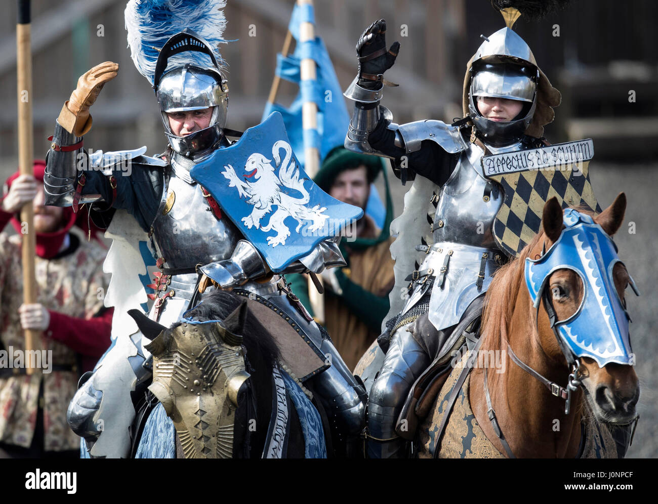 A man (left) and woman (right) dressed as knights take part in a ...