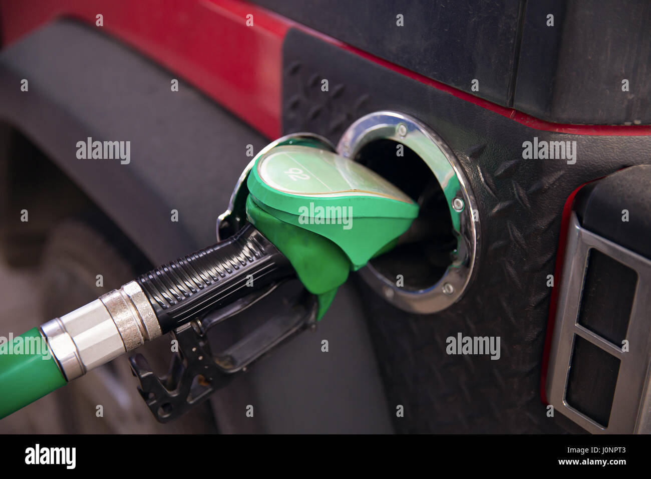 Buying petrol fuel on red car Stock Photo - Alamy