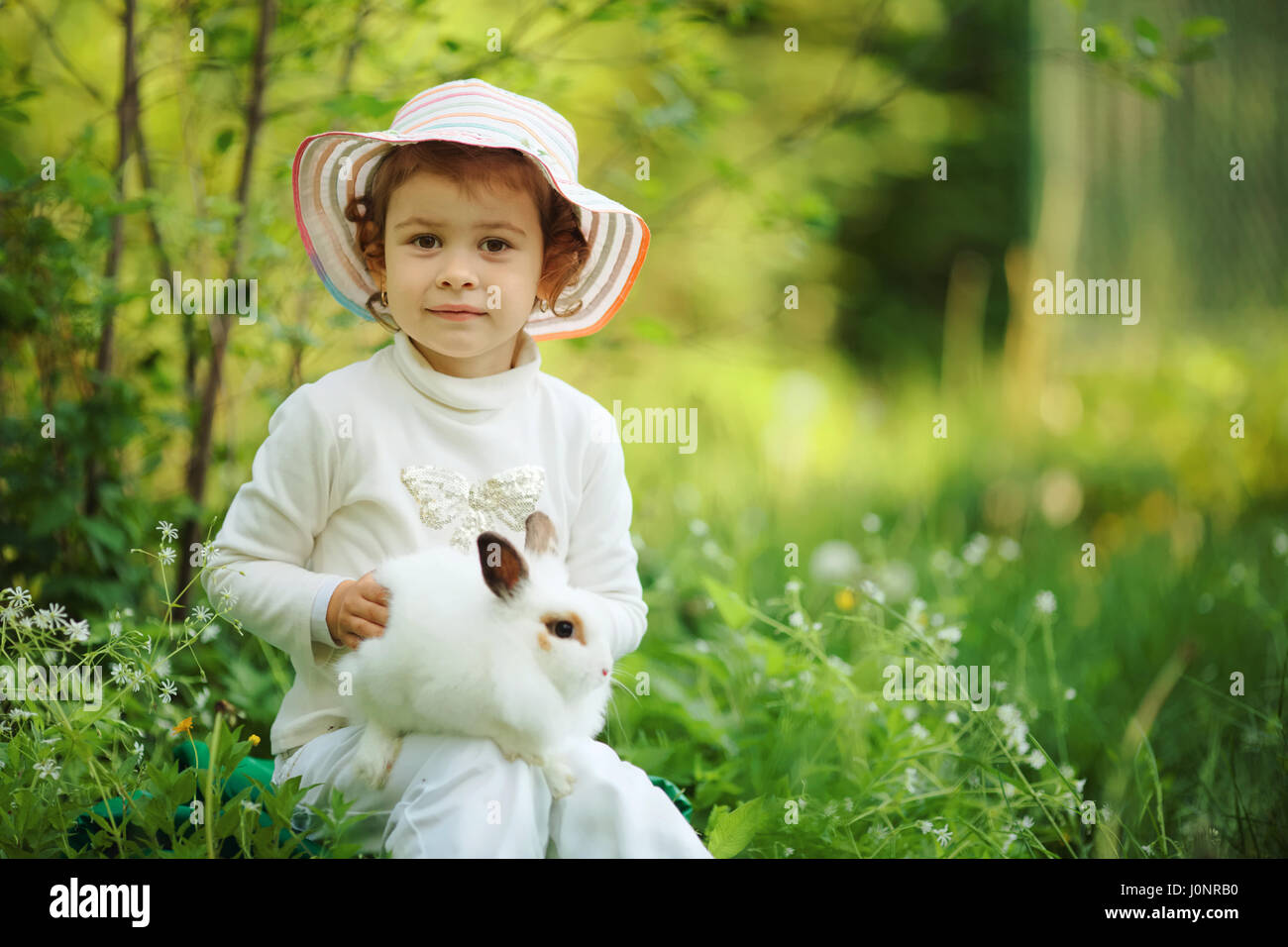 cute little girl with white rabbit Stock Photo - Alamy