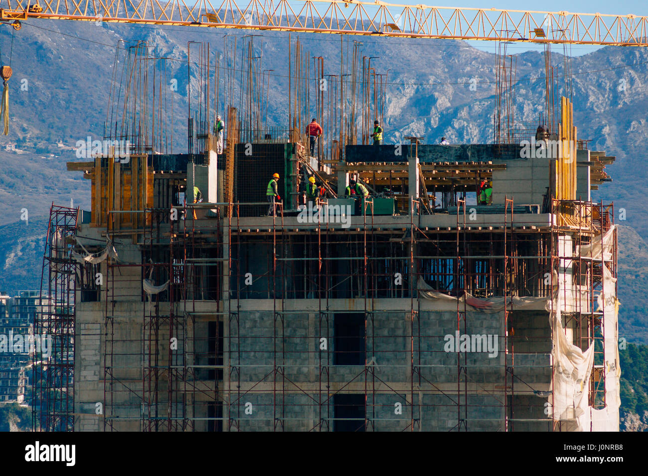 Construction of a multi-storey building. The crane is working. Budva ...