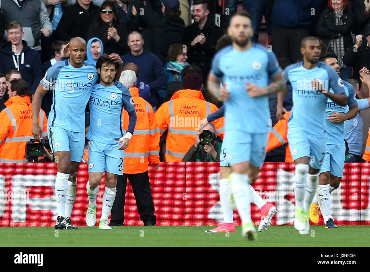 Manchester City's Vincent Kompany (left) celebrates scoring his side's ...
