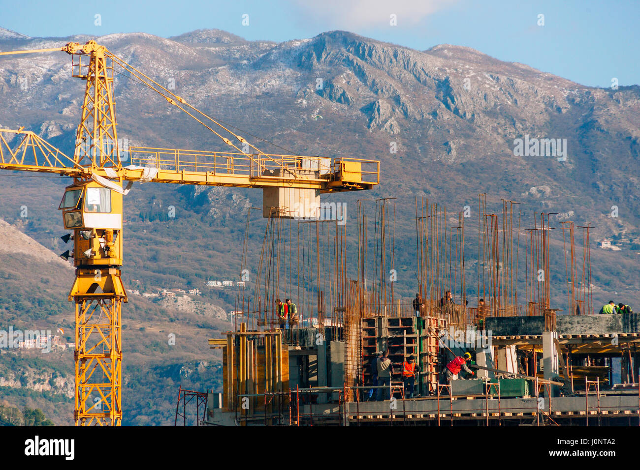 Construction of a multi-storey building. The crane is working. Budva ...