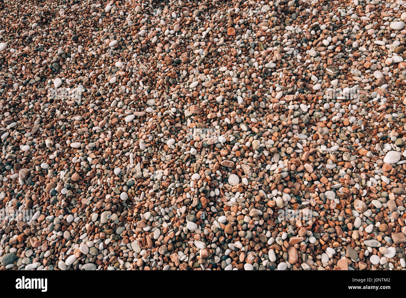 Pebbles on the beach. Texture of the sea shore. The Adriatic Sea in ...