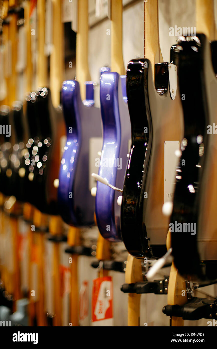 Rows of guitars for sale hanging in a shop Stock Photo - Alamy