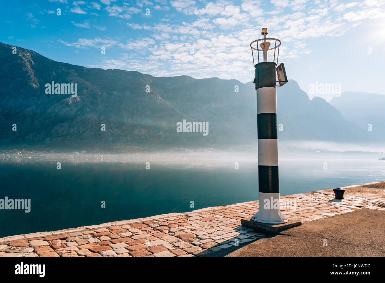 Black and white lighthouse in the sea. Prcanj, Kotor Bay, Montenegro ...