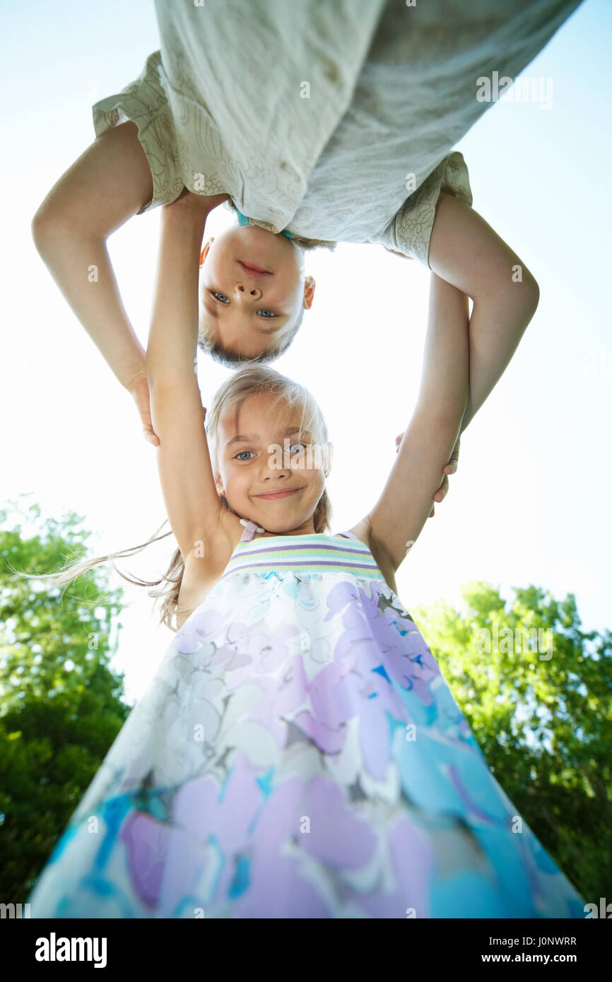 happy children hugging bottom view Stock Photo - Alamy