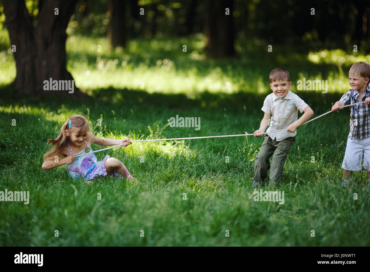 children pulling the rope outdoors Stock Photo - Alamy