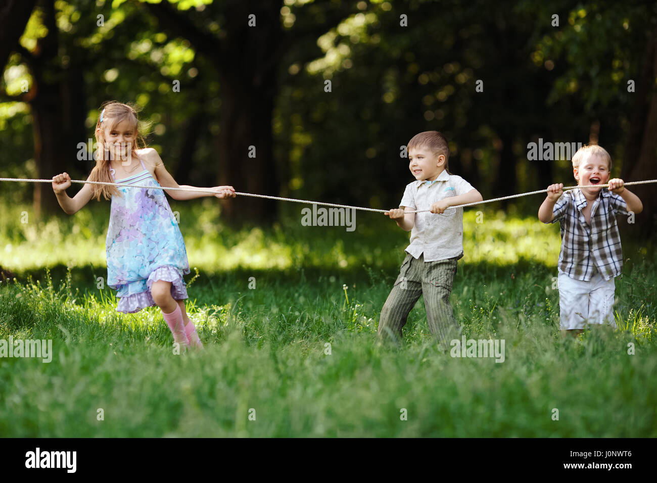 children pulling the rope outdoors Stock Photo - Alamy