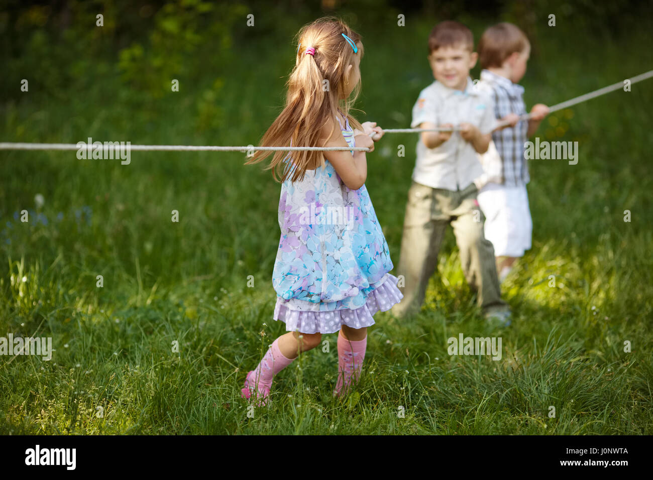 children pulling the rope outdoors Stock Photo - Alamy