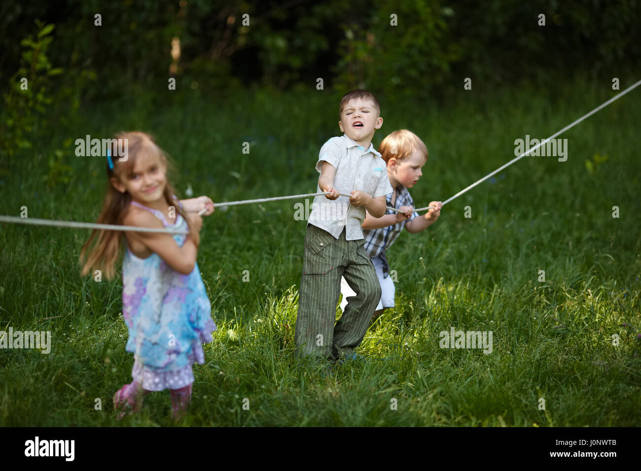 children pulling the rope outdoors Stock Photo - Alamy
