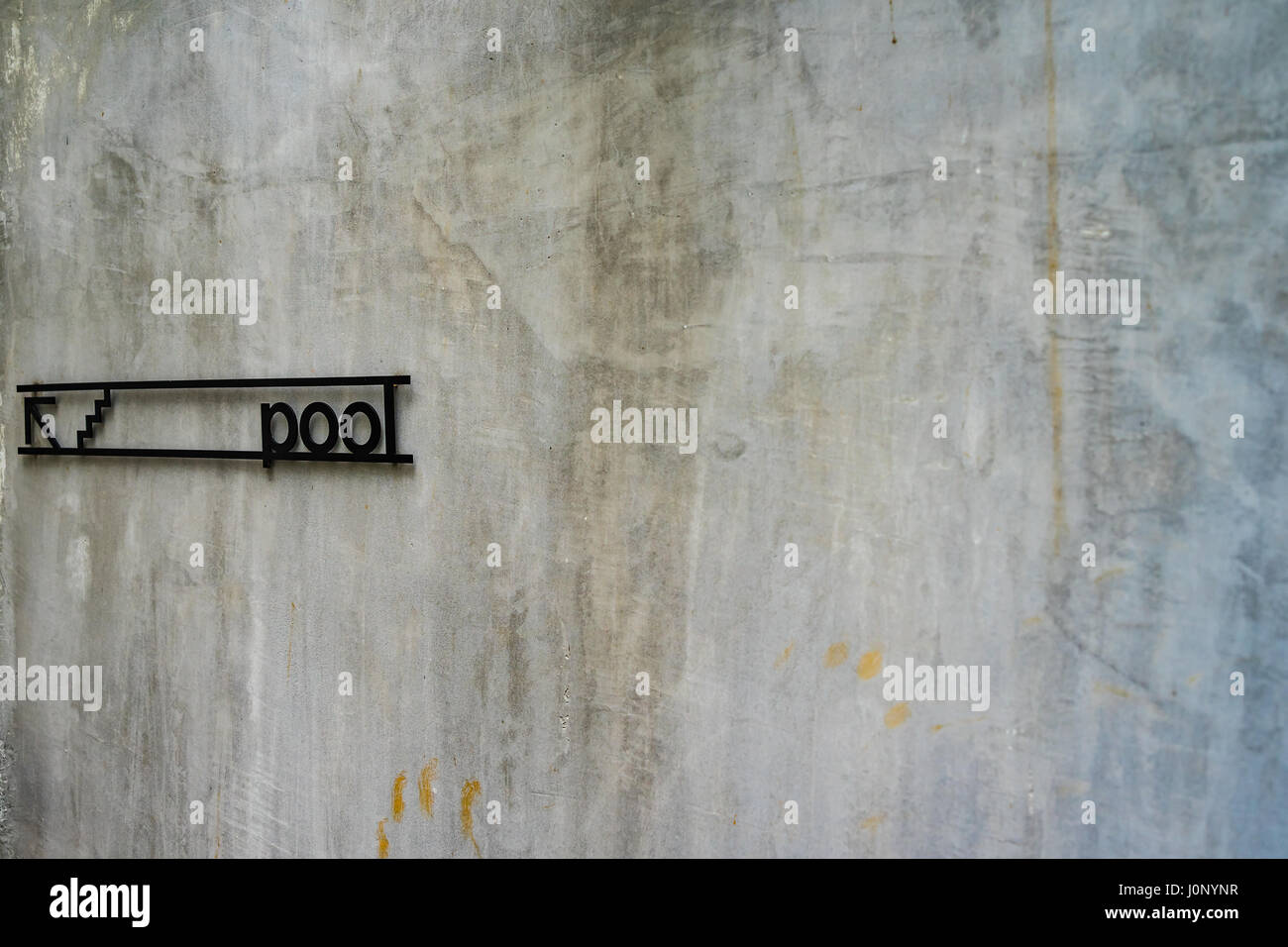 Stone wall with Pool Sign, Go to swimming pool Stock Photo - Alamy