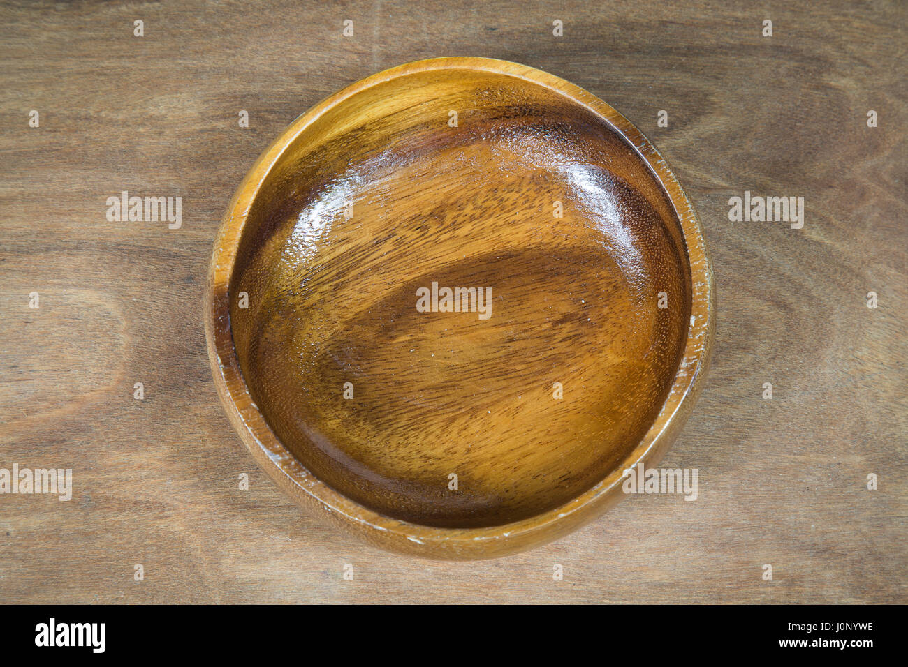 Empty round wooden bowl on wooden table, food display montage, top view ...
